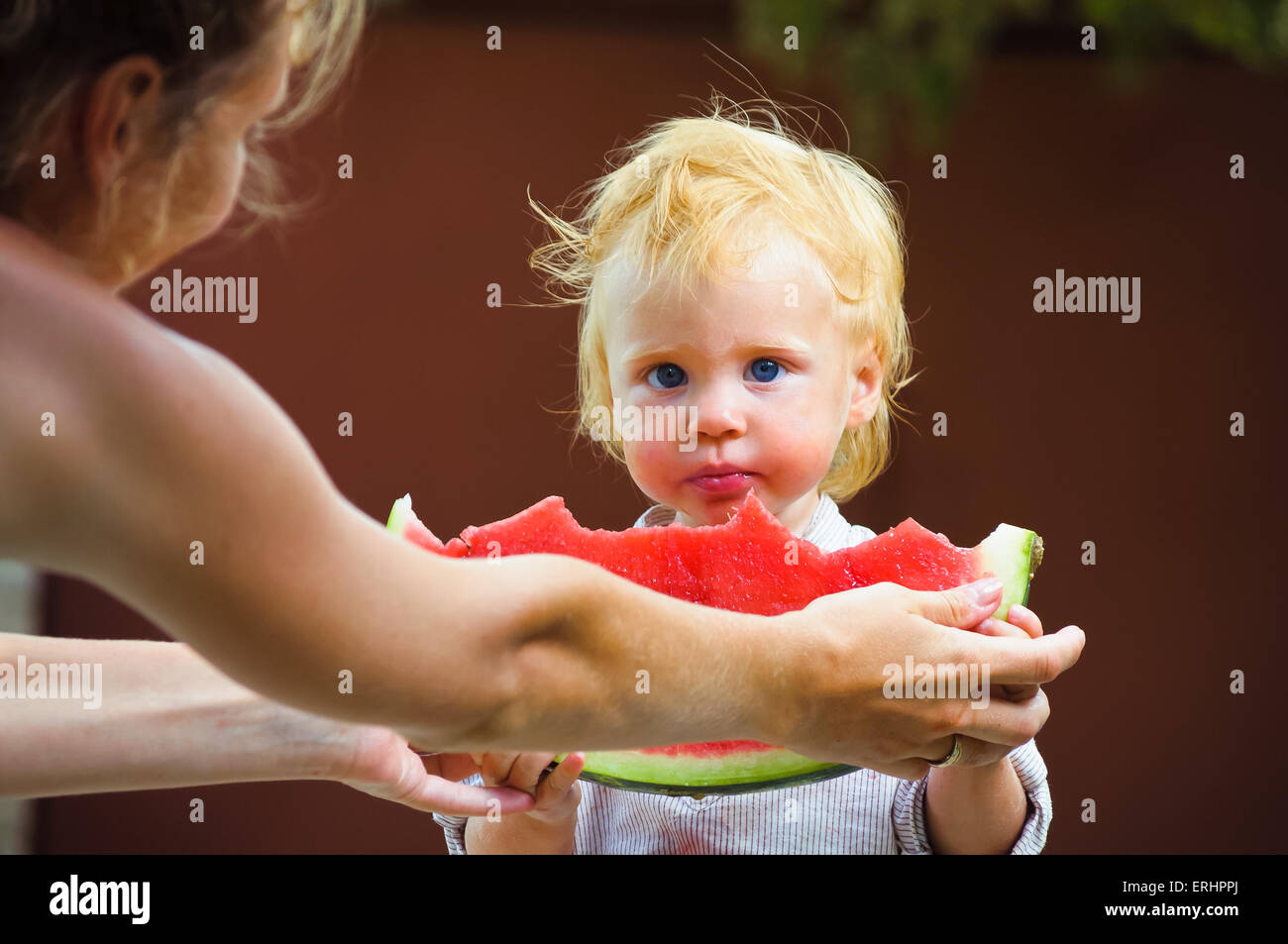 Cute infant baby with a delicious watermelon Stock Photo - Alamy
