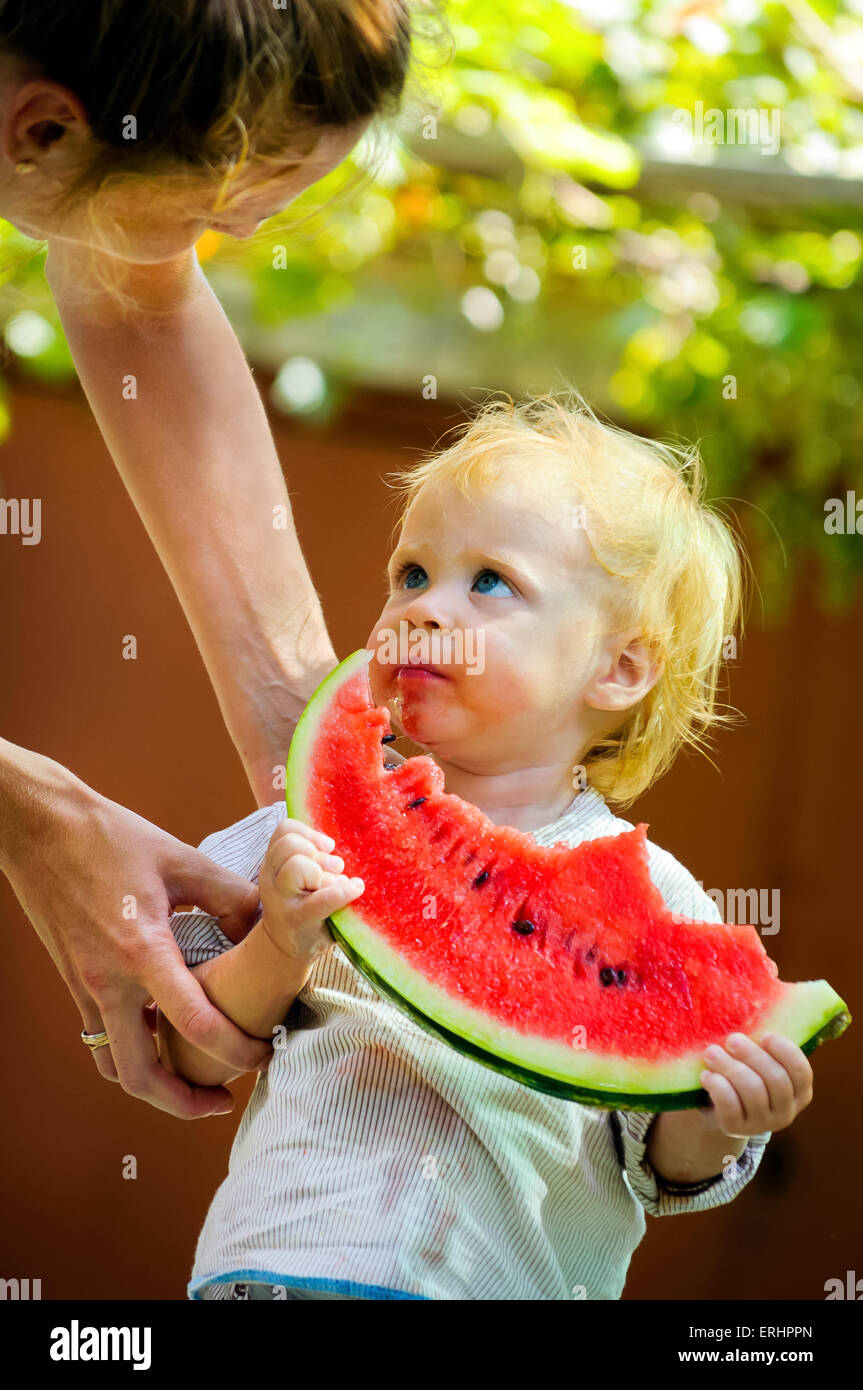 Cute infant baby with a delicious watermelon Stock Photo - Alamy