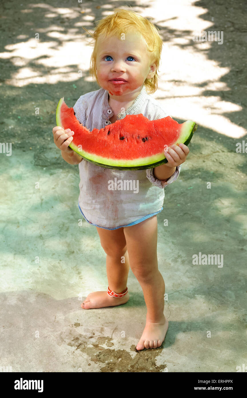 Cute infant baby with a delicious watermelon Stock Photo - Alamy