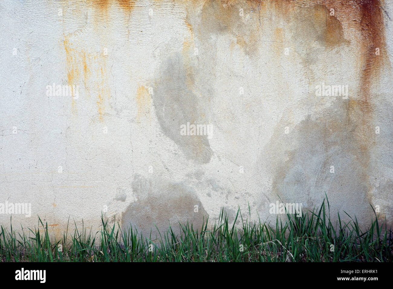 a cracked and rusty wall with grass Stock Photo - Alamy