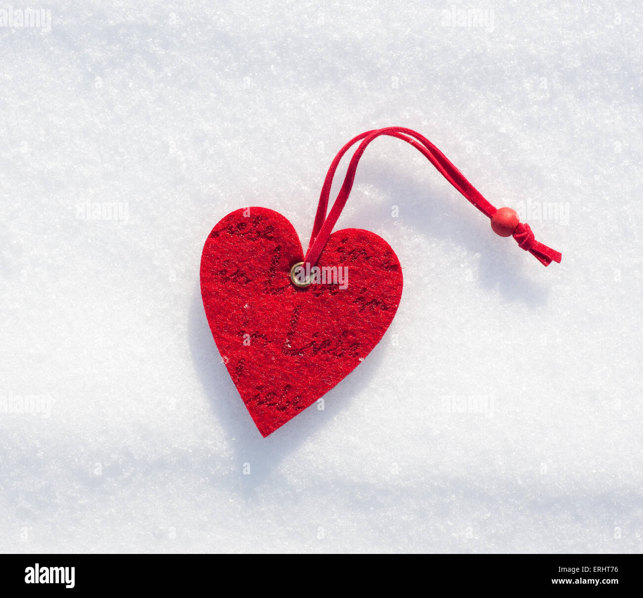 red heart on snow background Stock Photo - Alamy