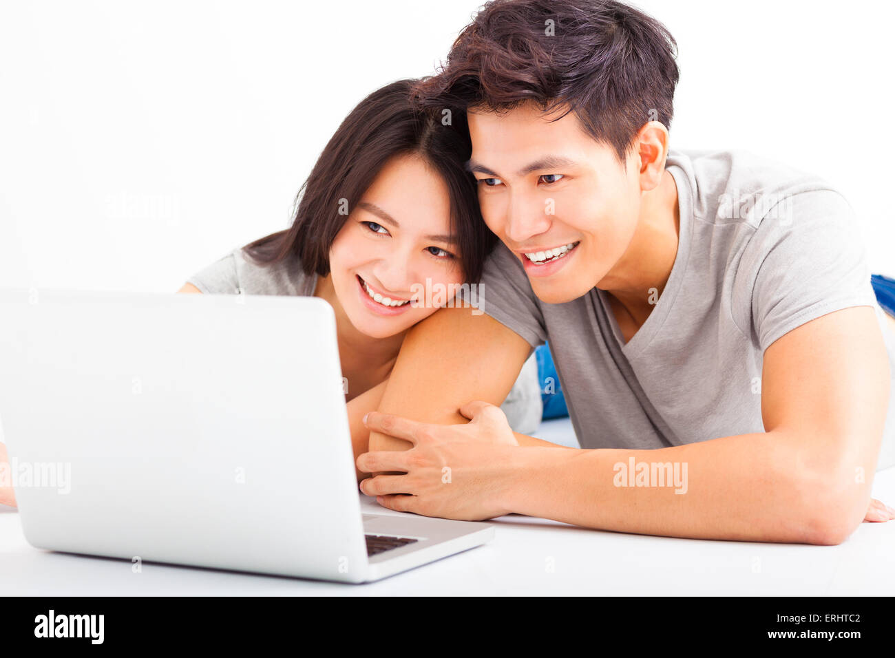 Young happy couple watching the laptop Stock Photo - Alamy