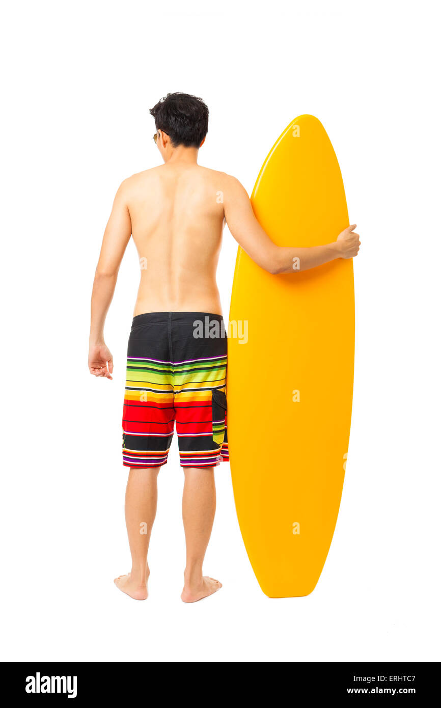 rear view young man holding surfboard Stock Photo - Alamy