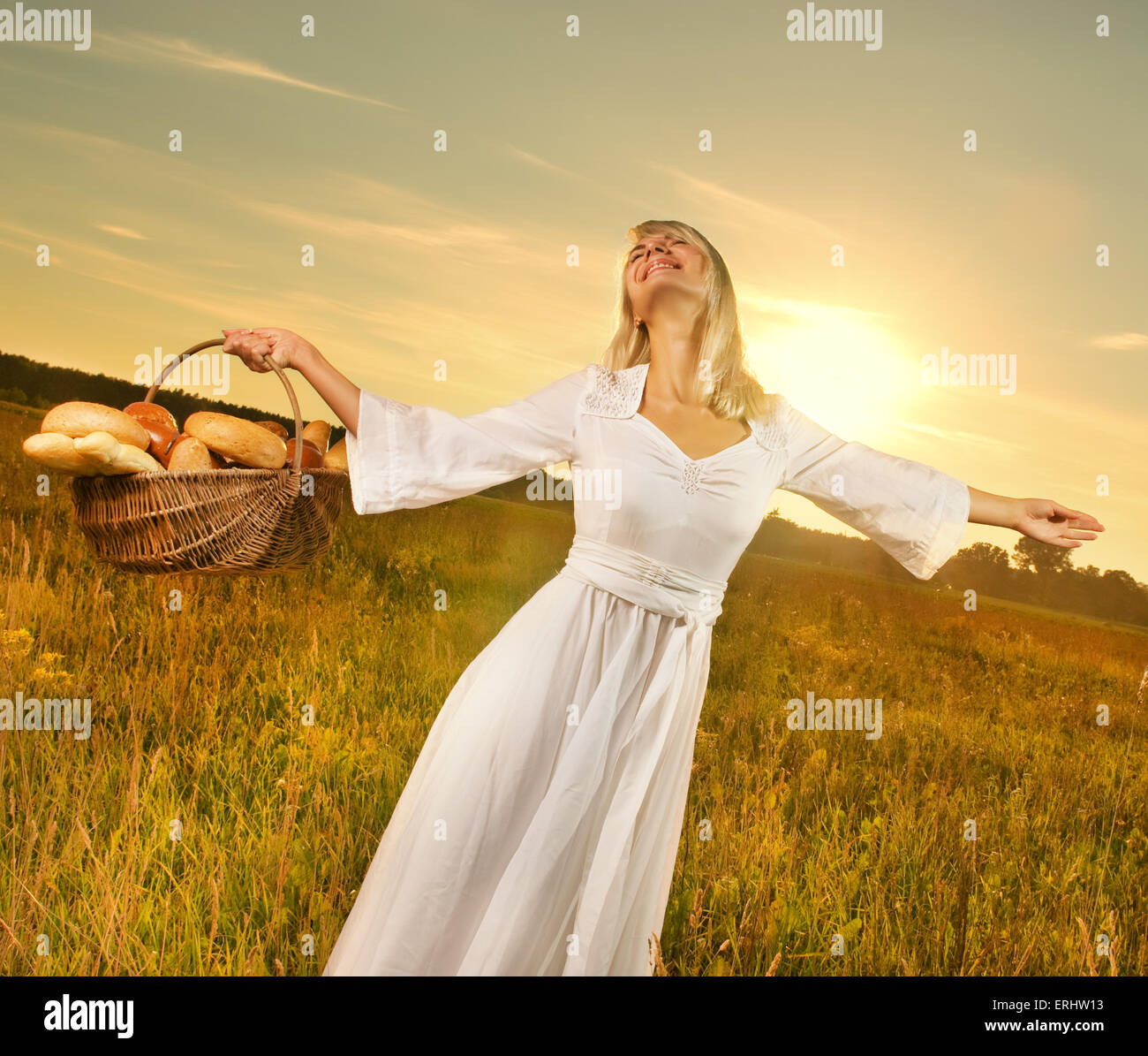 Beautiful young woman with a basket full of fresh baked bread Stock ...