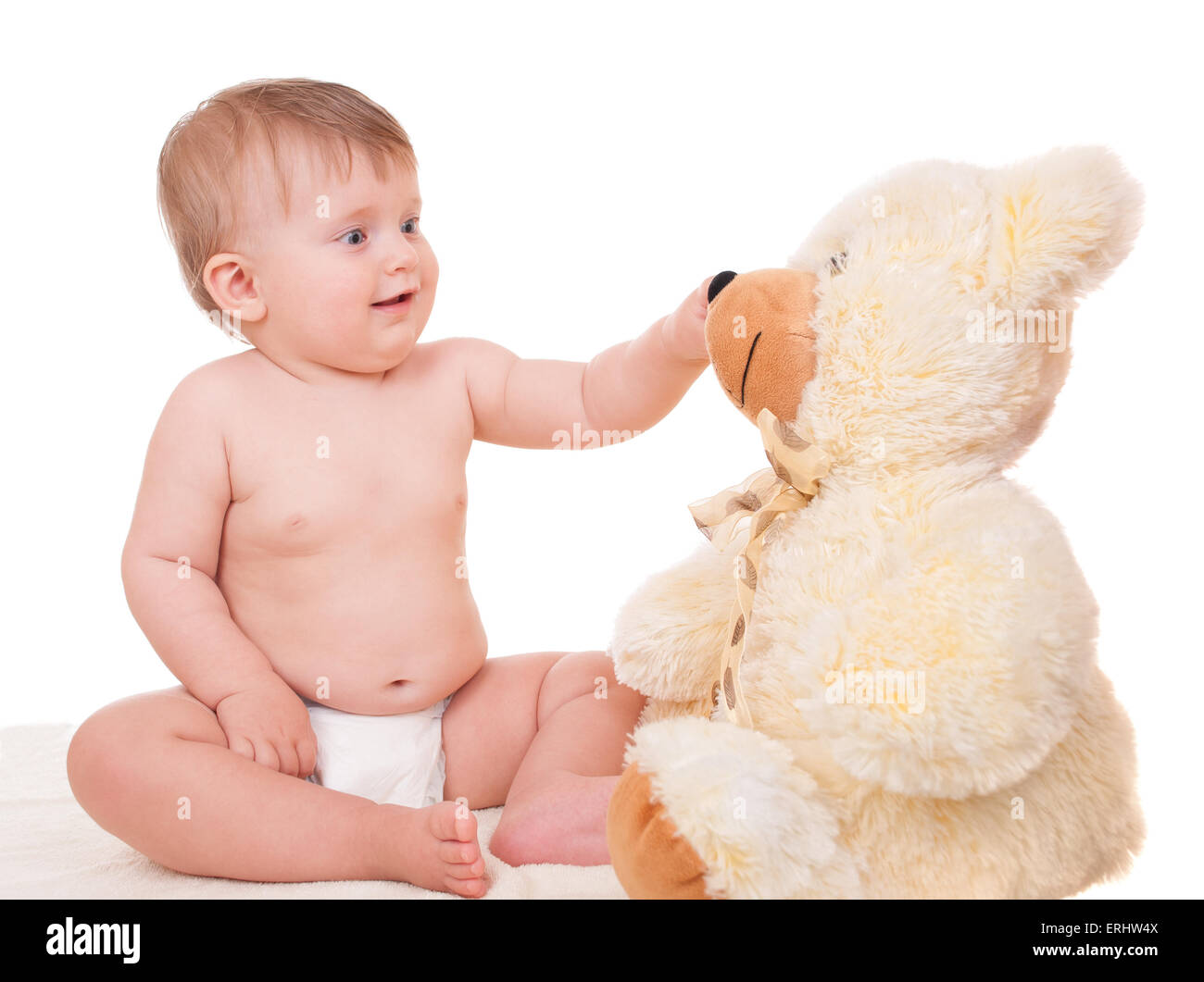 smiling baby playing with teddy bear Stock Photo - Alamy