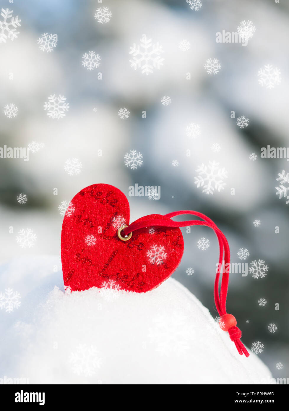 red heart toy in snowfall on fir tree Stock Photo - Alamy