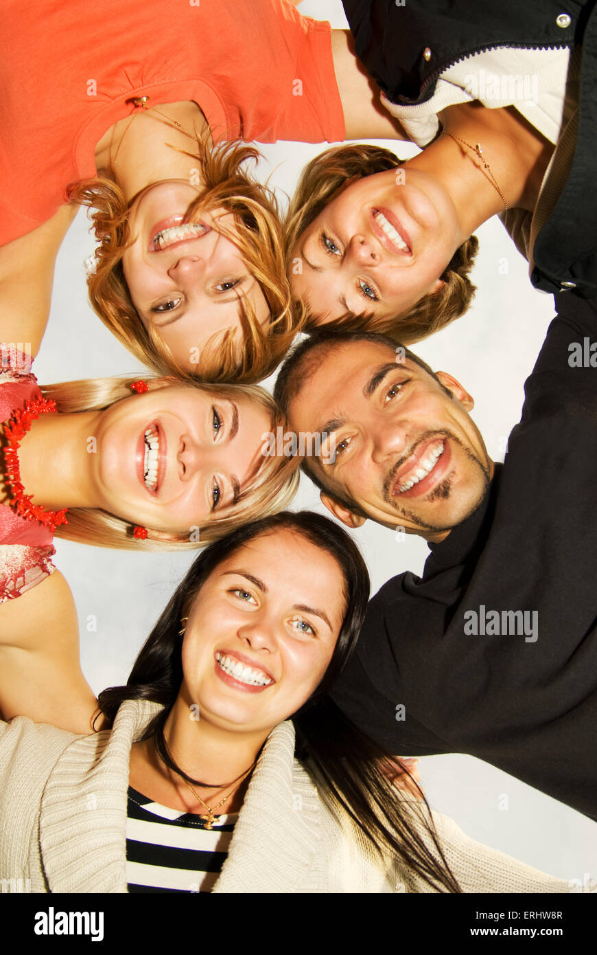 Group of happy friends standing in circle Stock Photo - Alamy