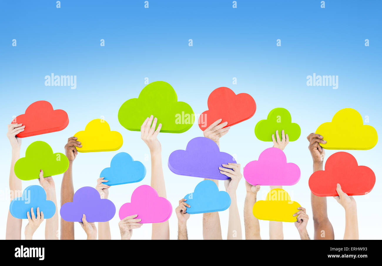 Hands holding multi colored cloud shaped speech bubbles with blue sky ...