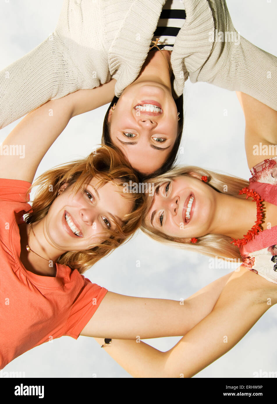 Group of happy friends standing in circle Stock Photo - Alamy