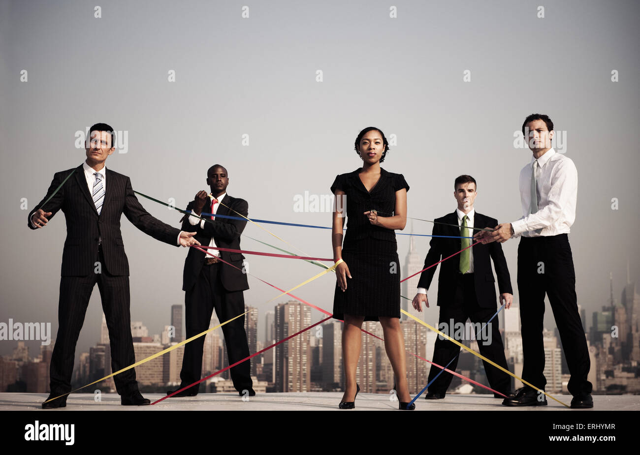 Business people connected by strings Stock Photo - Alamy