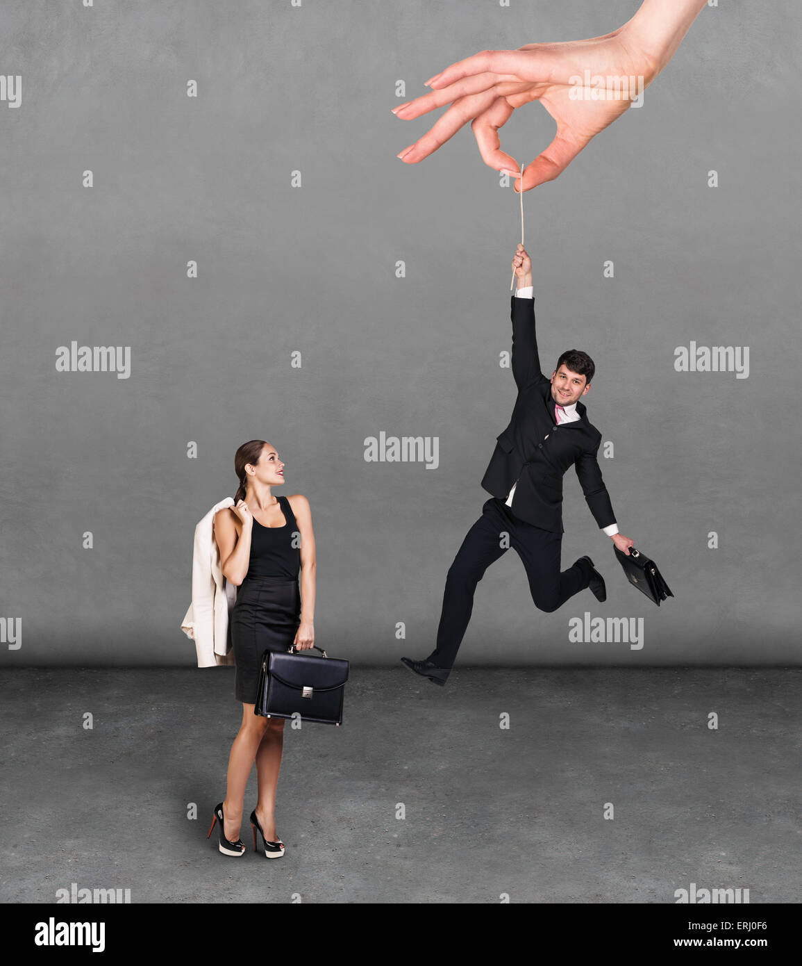 Big hand holding a business man Stock Photo - Alamy