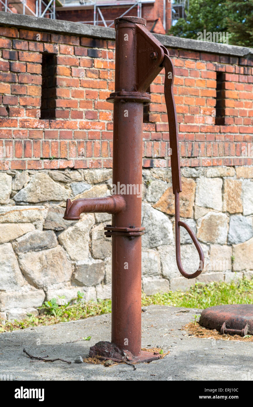 Old metal corroded brown manual rusty pump Stock Photo - Alamy