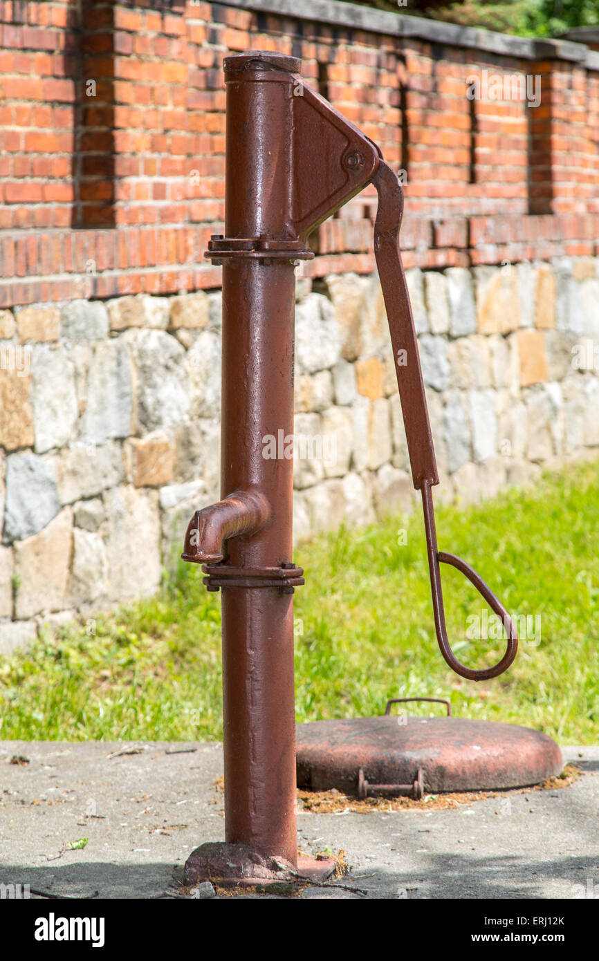 Old metal corroded brown manual rusty pump Stock Photo - Alamy