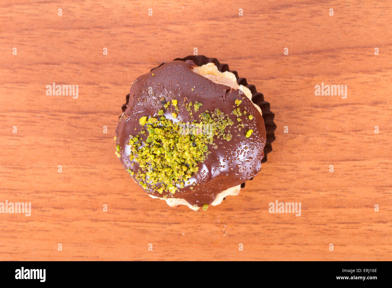 Chocolate cake with pistachio particles on wooden background Stock ...