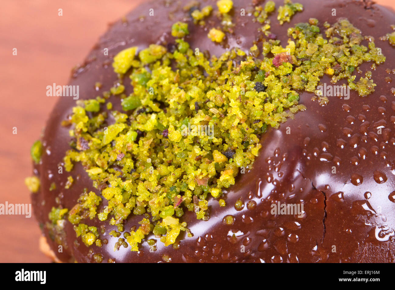 Chocolate cake with pistachio particles on wooden background Stock ...