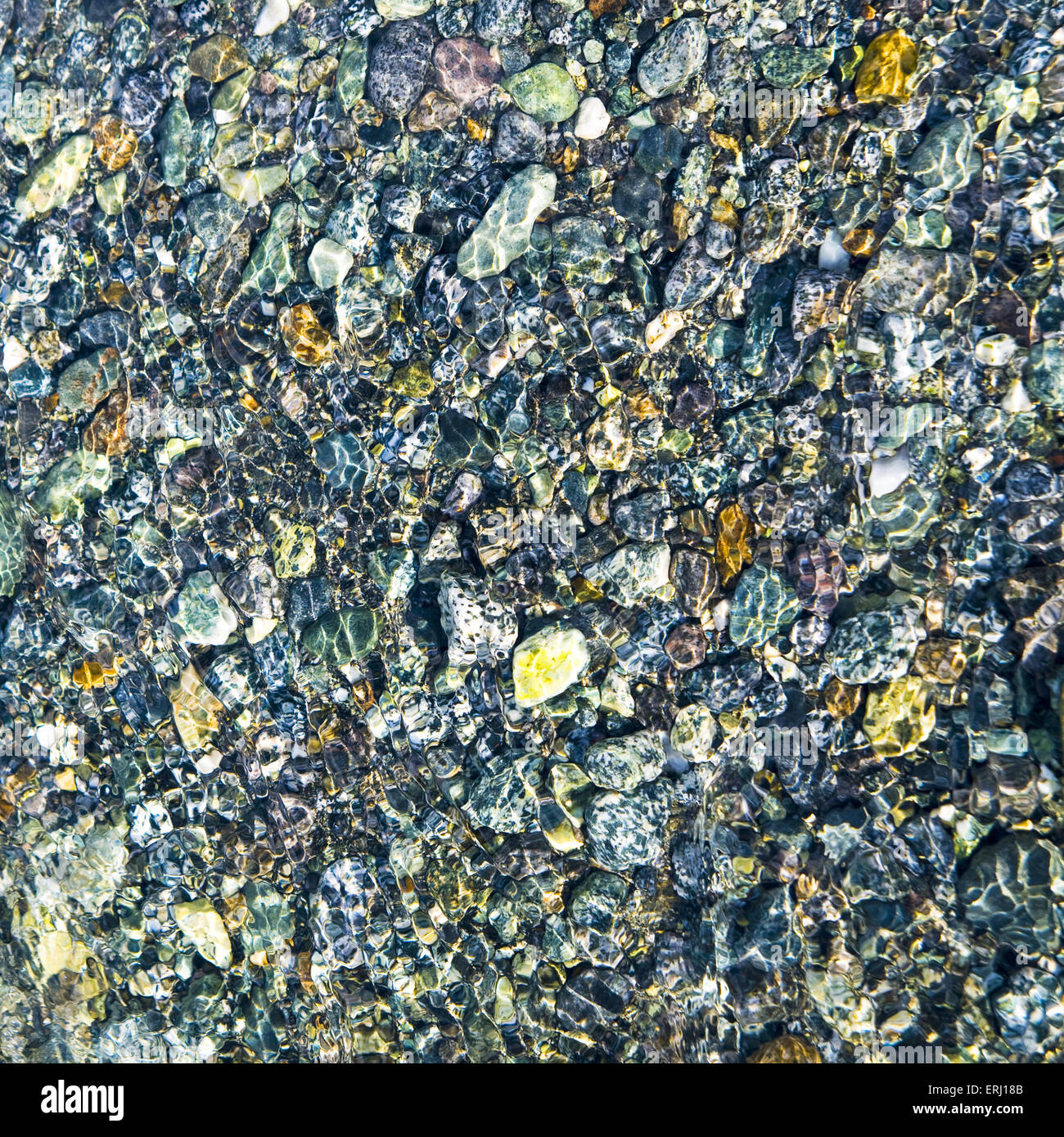 Pebbles rocks covered with water Stock Photo - Alamy