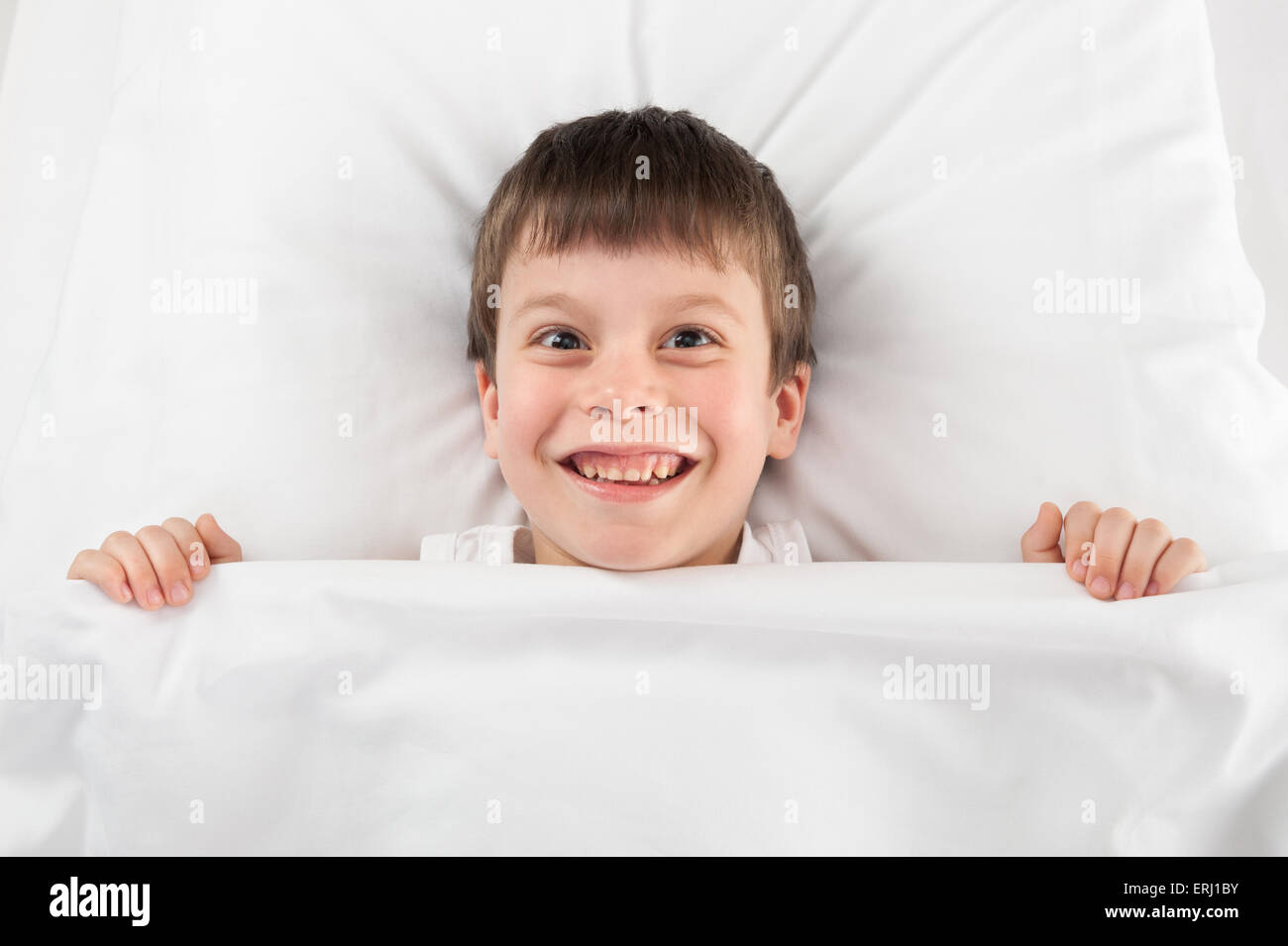 cheerful boy in white bed Stock Photo - Alamy cheerful boy in white bed Stock Photo - Alamy
