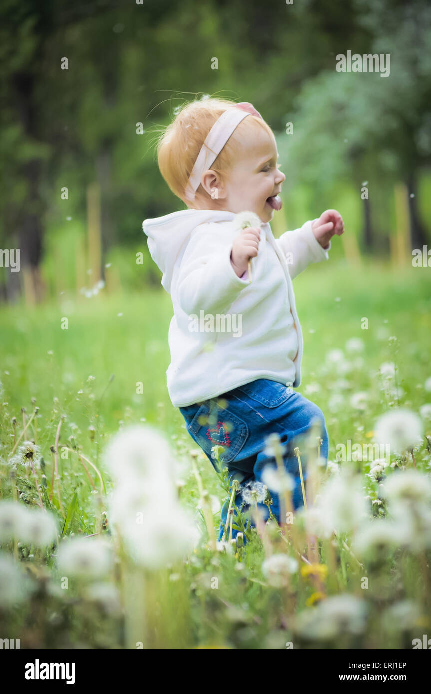Outdoor portrait of a cute little baby in the grass Stock Photo - Alamy