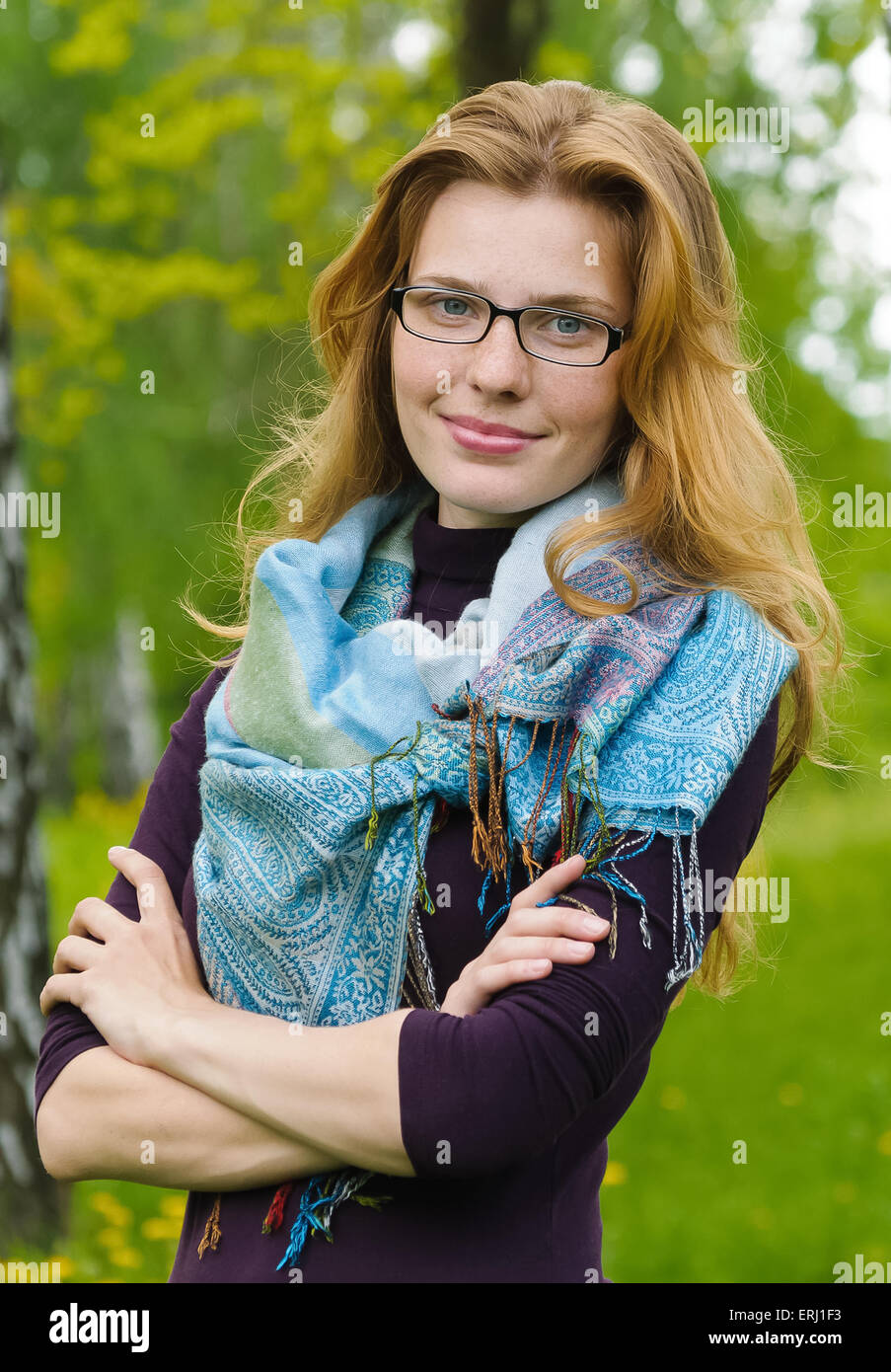 Portrait of young serious woman standing at summer green park Stock ...