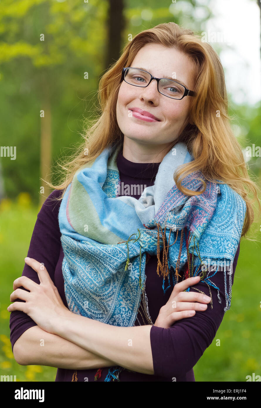 Portrait of young serious woman standing at summer green park Stock ...