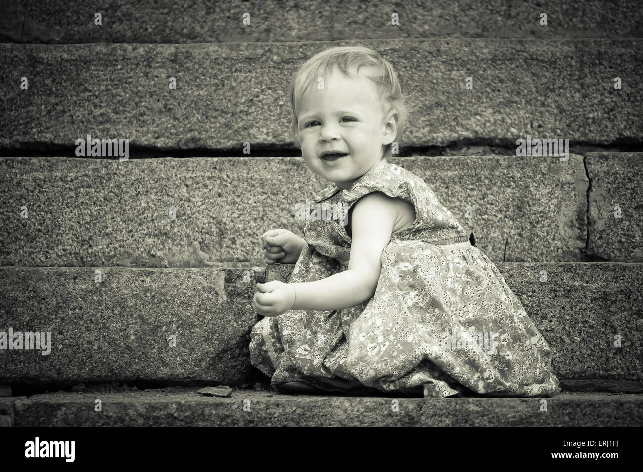 Cute Little baby find something on the ground - outdoors. B&W version ...