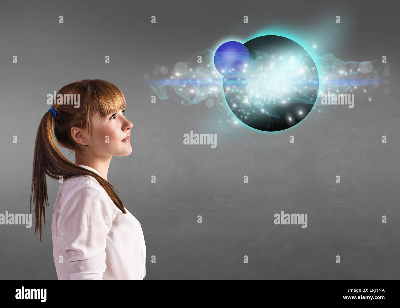 Girl looking at a planet Stock Photo - Alamy