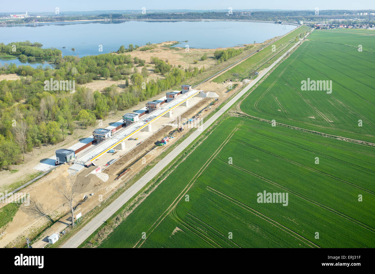 Construction of a modern dam on the lake Stock Photo - Alamy