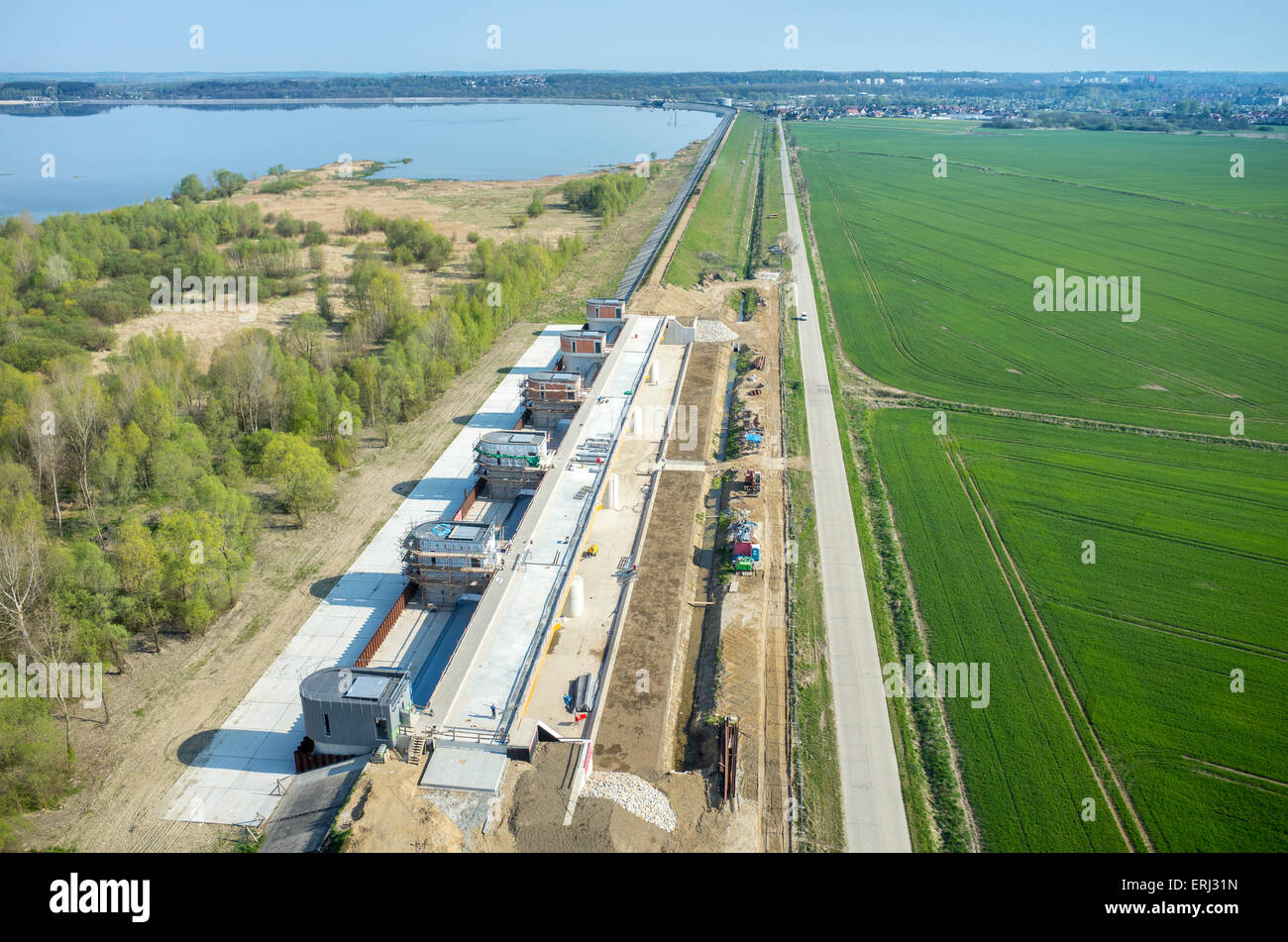 Construction of a modern dam on the lake Stock Photo - Alamy