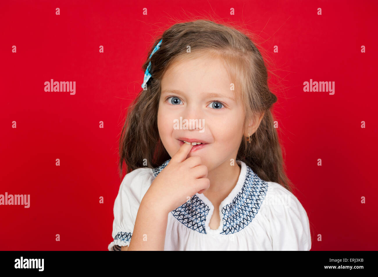 girl with finger in mouth Stock Photo - Alamy
