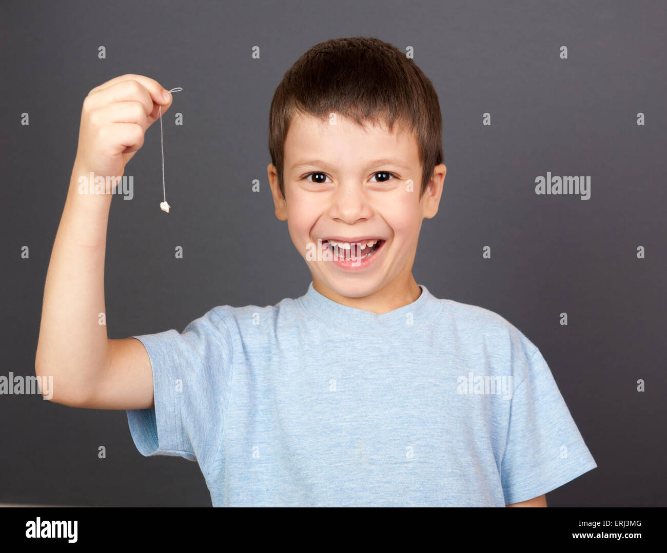 boy show lost tooth on a thread Stock Photo - Alamy