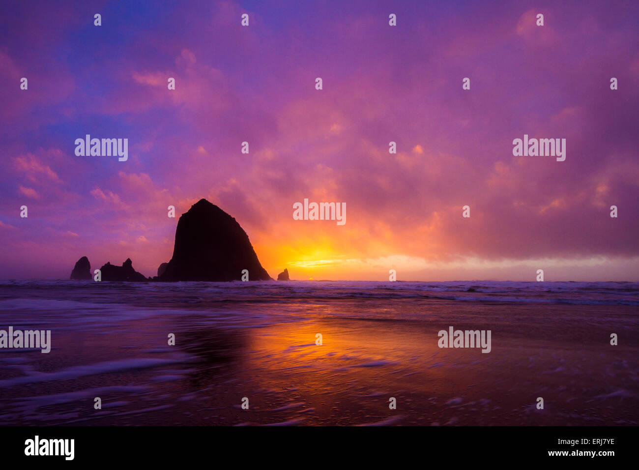 Sunset and reflections at Haystack Rock, Cannon Beach, Oregon Stock Photo - Alamy