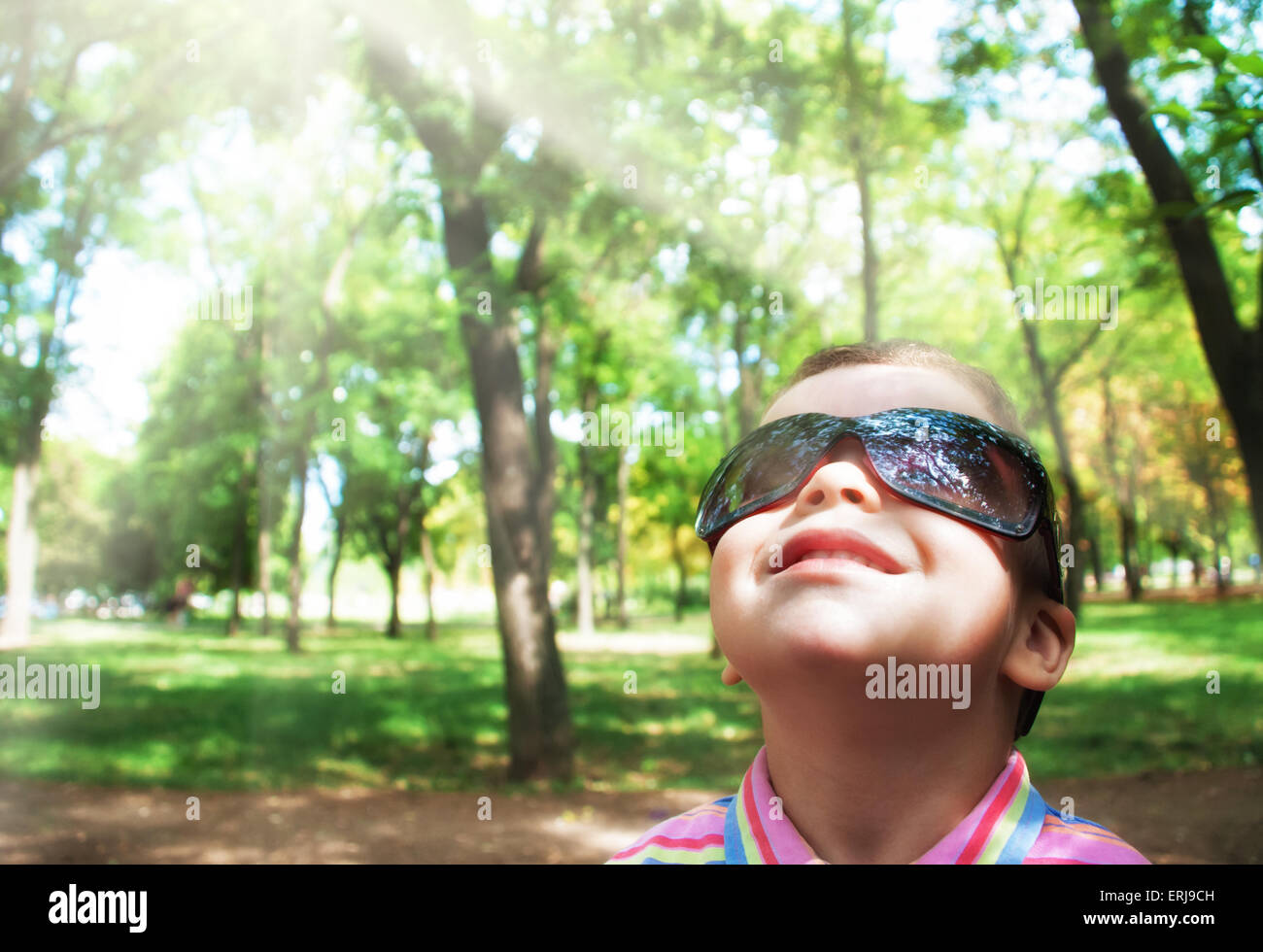 boy in sunglasses looking at the sun Stock Photo - Alamy