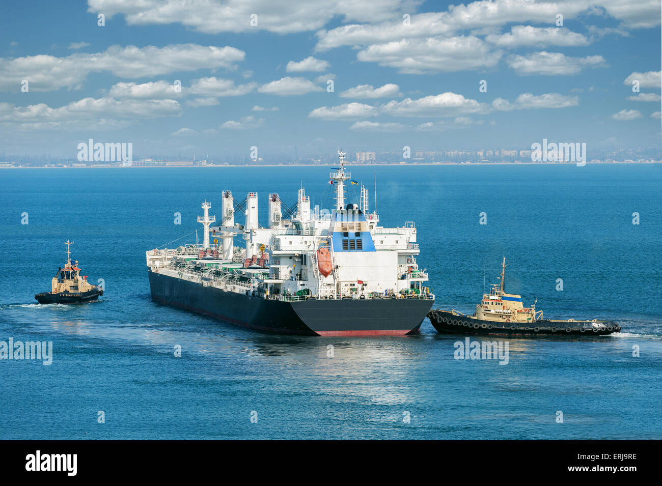 cargo ship and tug boat Stock Photo - Alamy