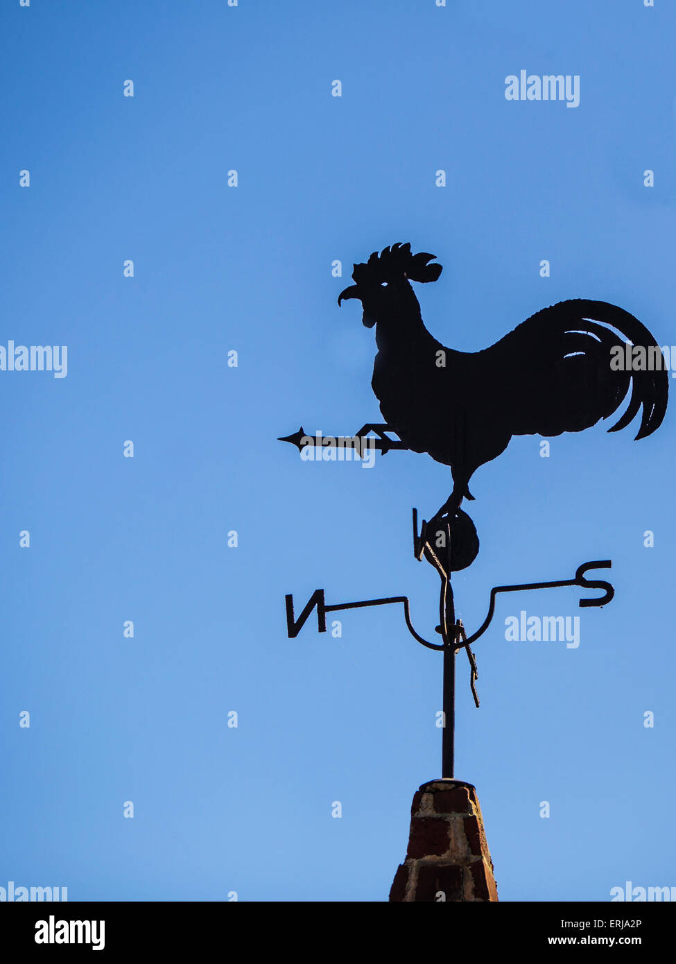 White rooster weather vane show the wind direction on blue sky ...