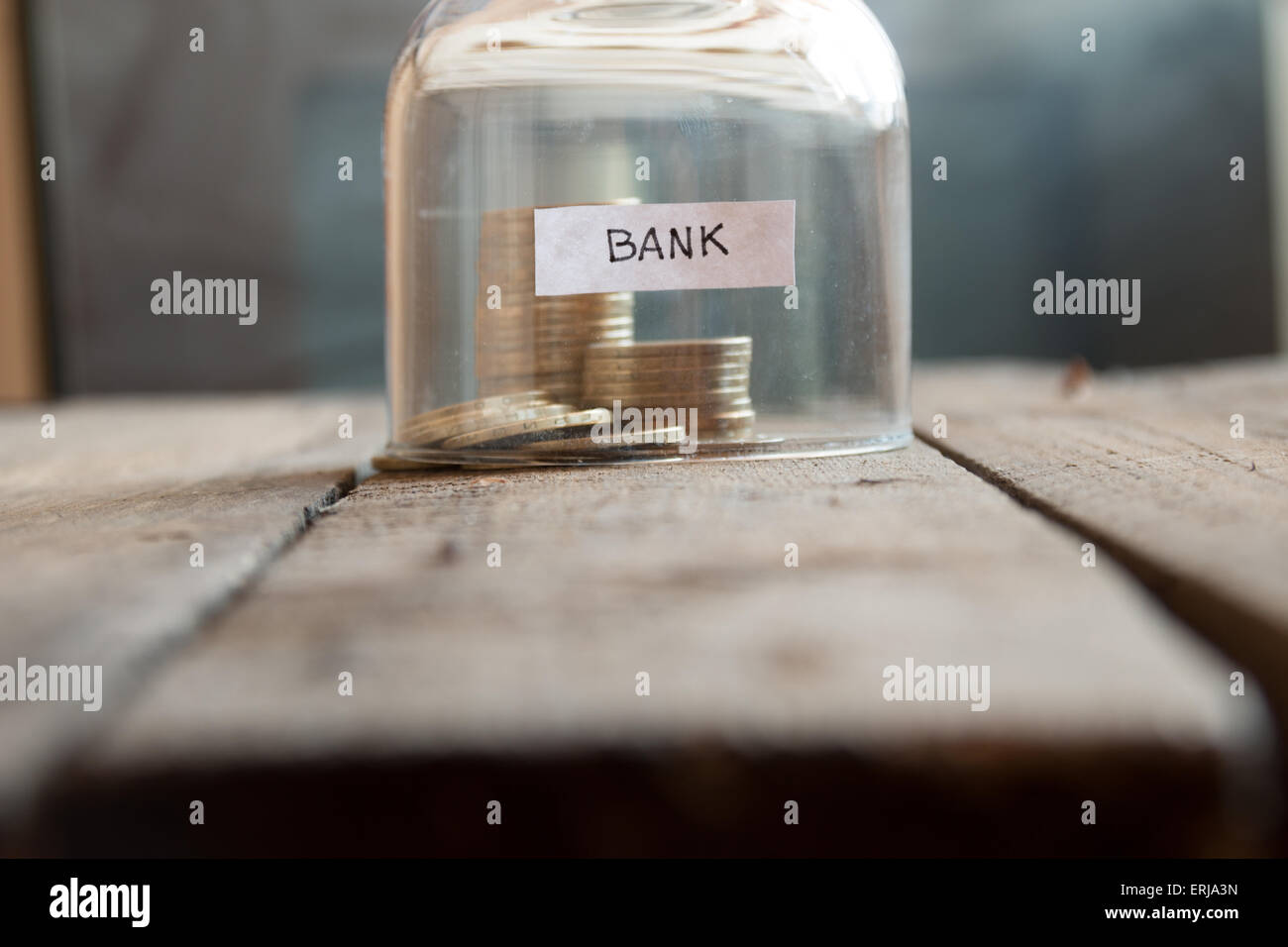 Bank Concept. Gold coins on a table under a glass cover Stock Photo - Alamy