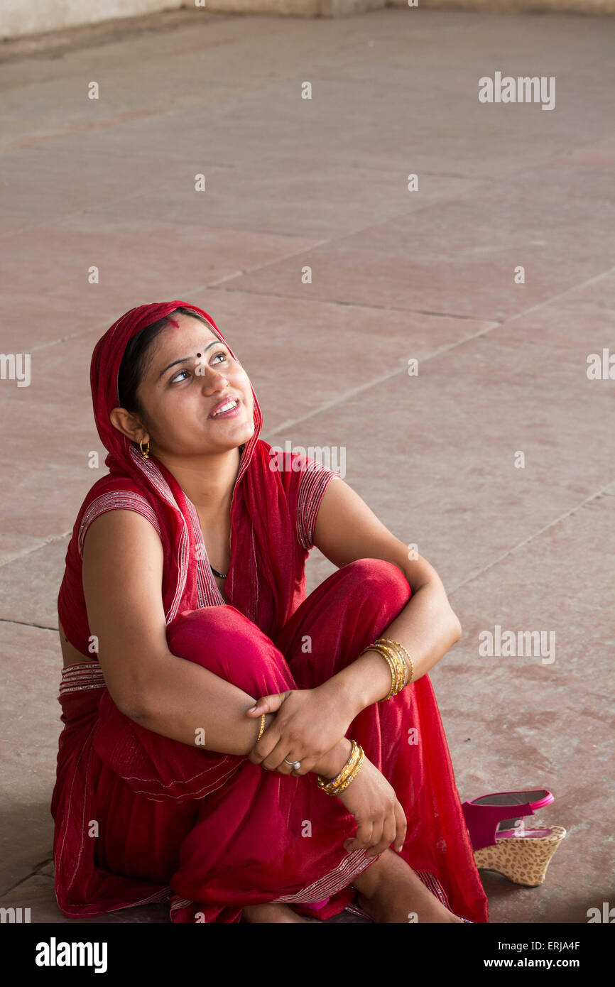 India, Agra. The Red Fort of Agra. Young Indian woman in red sari Stock ...
