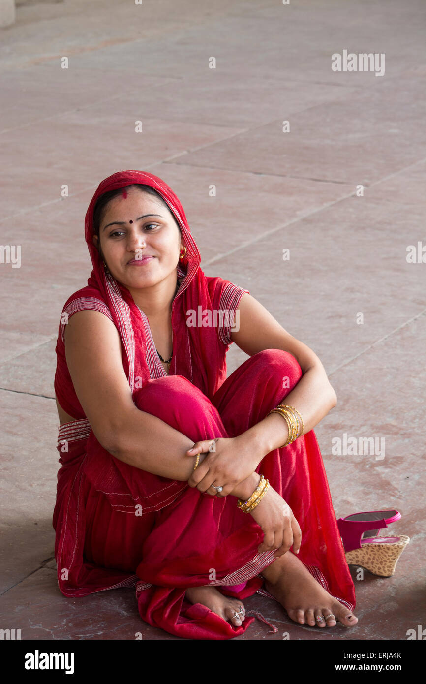 India, Agra. The Red Fort of Agra. Young Indian woman in red sari Stock ...