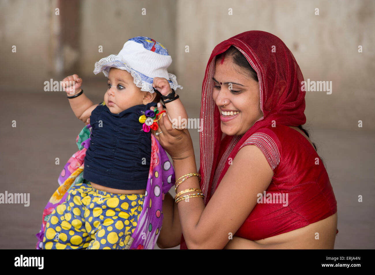 India, Agra. The Red Fort of Agra. Young Indian woman in red sari, with ...