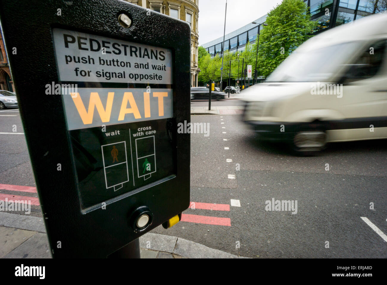 Traffic speeds past a pedestrian crossing with a look right sign Stock ...