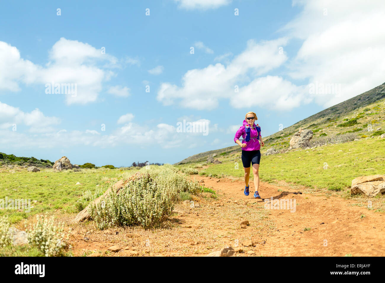 Trail running woman cross country running in mountains on summer ...