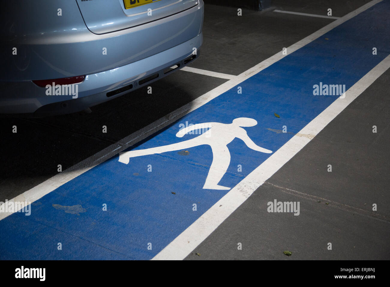 Pedestrian walkway marked in blue in a UK multi storey car park Stock ...