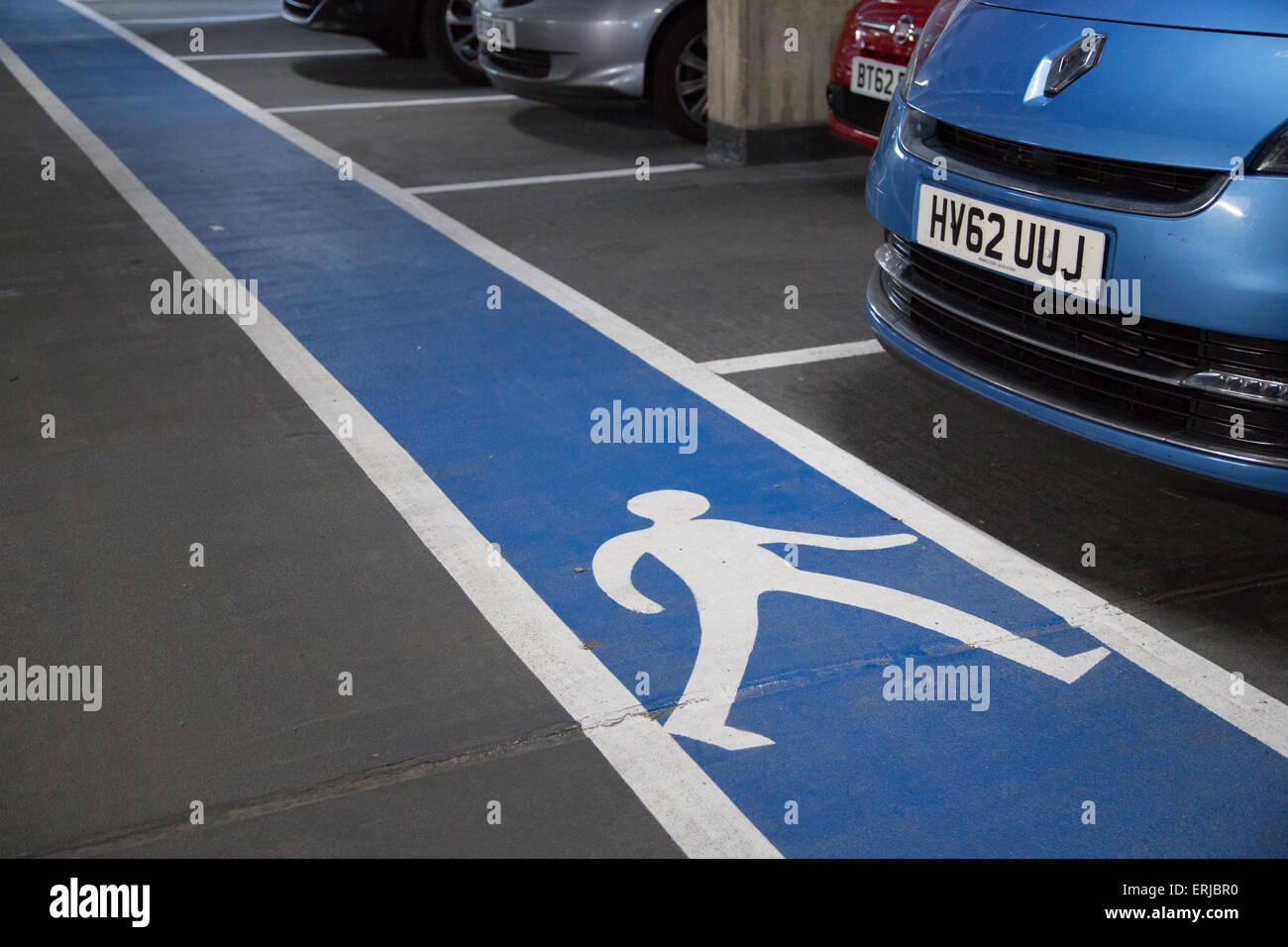 Pedestrian walkway marked in blue in a UK multi storey car park Stock ...