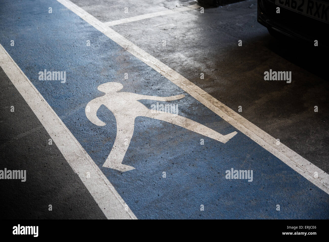 Pedestrian walkway marked in blue in a UK multi storey car park Stock ...