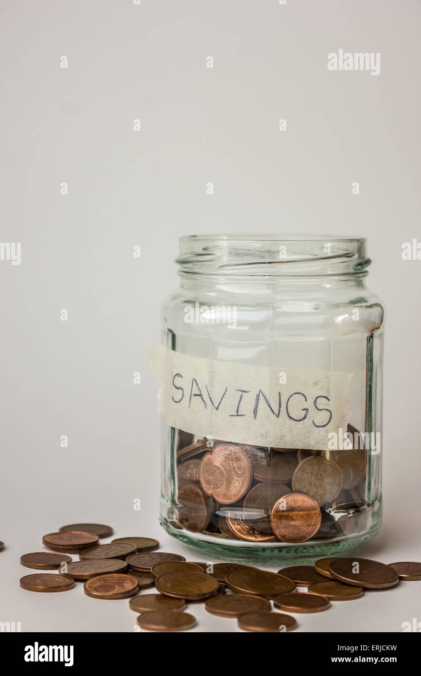 Jar with coins. Savings and tips Stock Photo - Alamy
