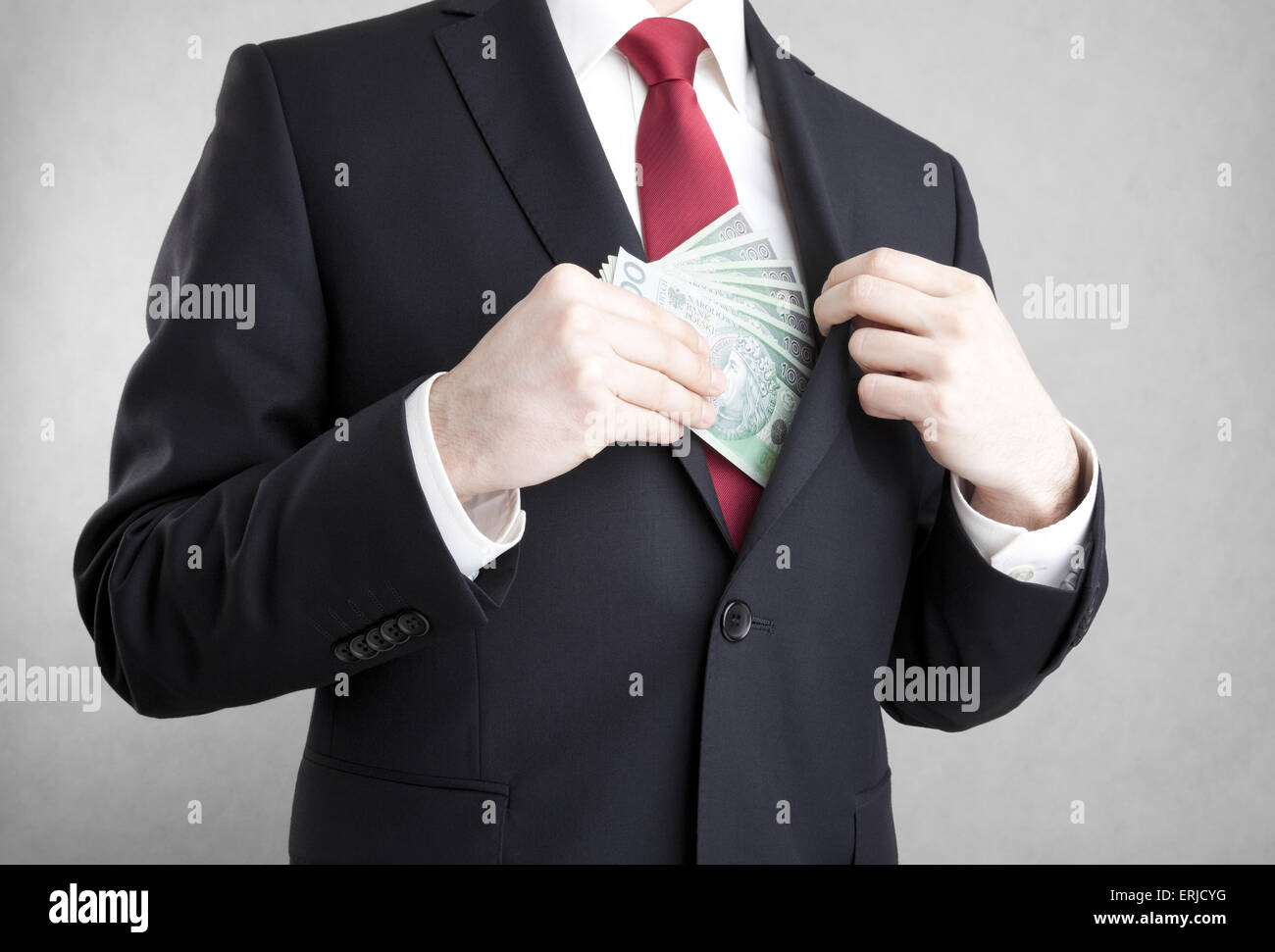 Corruption. Man putting polish money in suit jacket pocket Stock Photo ...