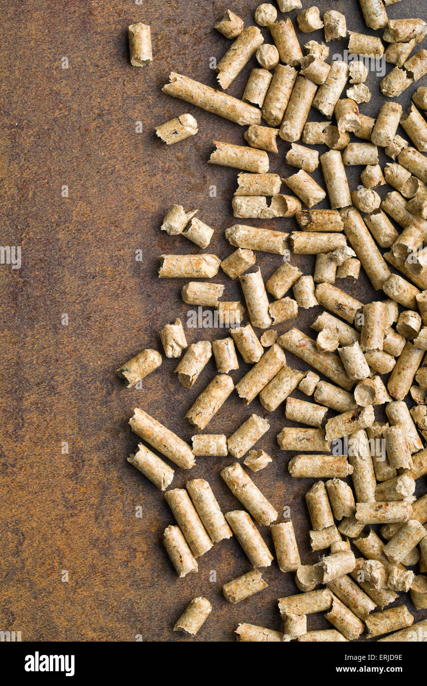 wooden pellets on old rusty background Stock Photo - Alamy