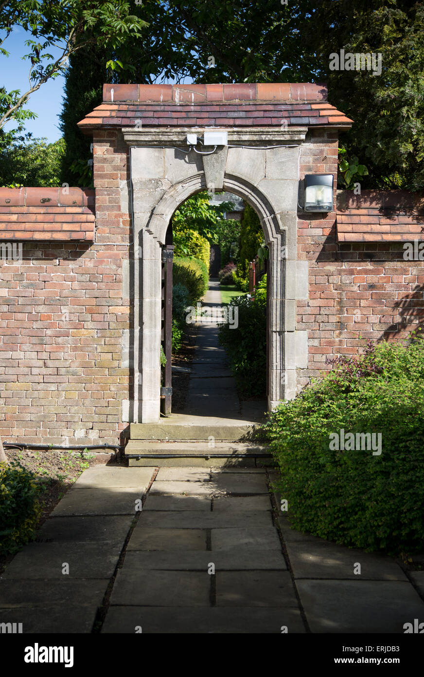 A stone archway in an english country garden Stock Photo - Alamy