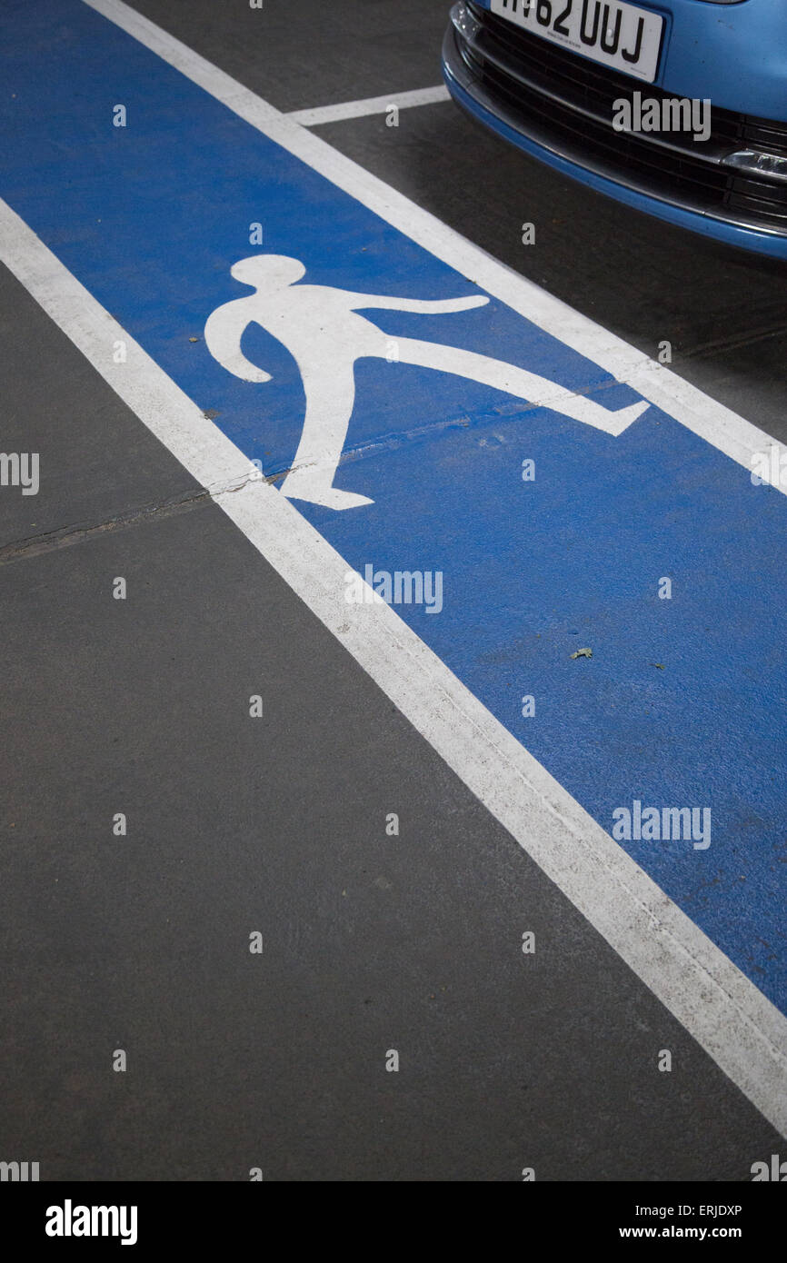 Pedestrian walkway marked in blue in a UK multi storey car park Stock ...