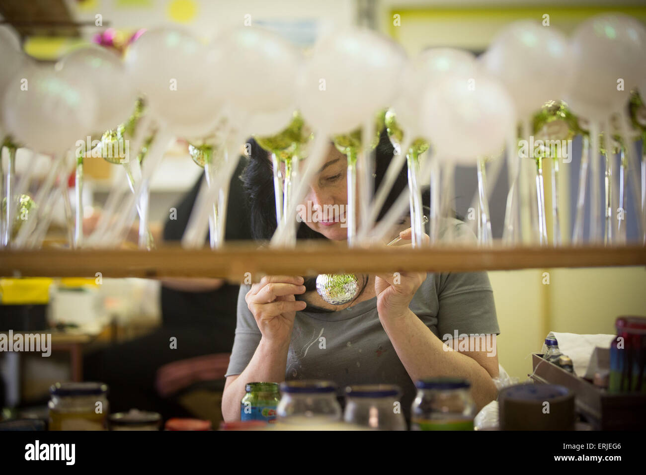 Worker completes glass ornaments in Slezska Tvorba factory in Opava ...