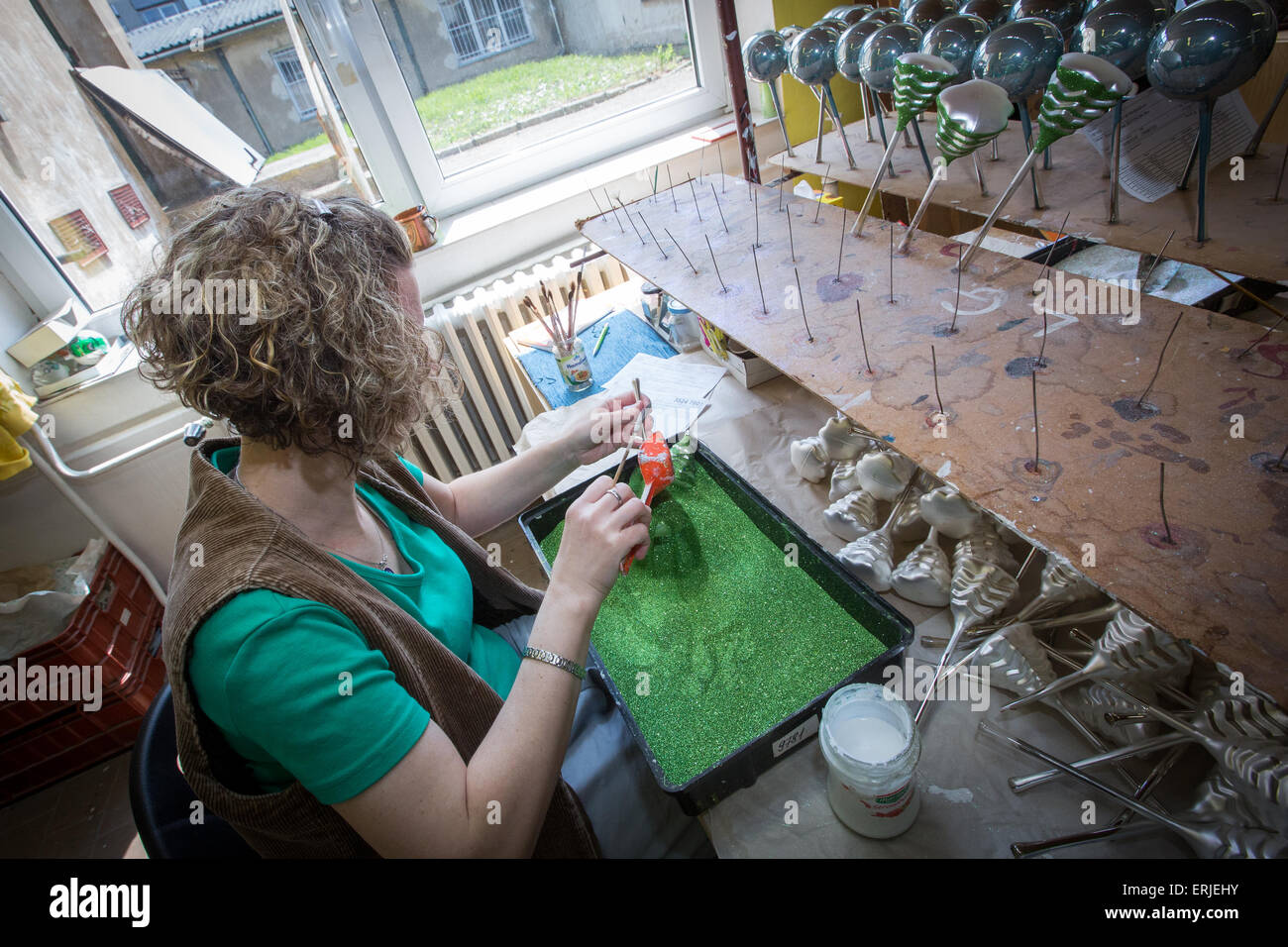 Worker completes glass ornaments in Slezska Tvorba factory in Opava ...